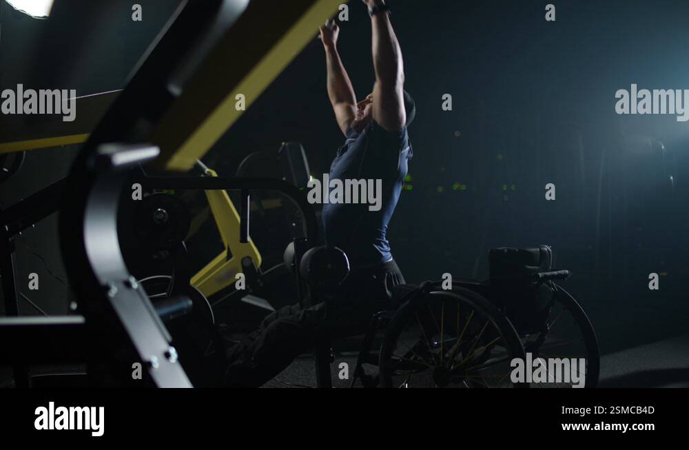 Fortitude, disabled athlete in wheelchair lifting blocks on a gym ...