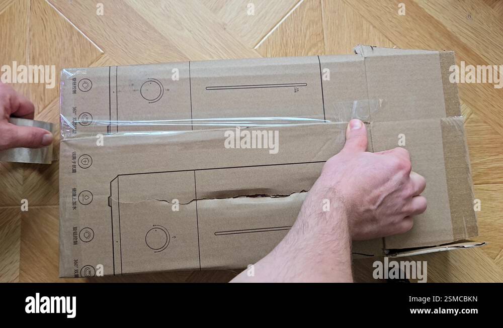 Packing the product in a box. wrapping the box with adhesive tape Stock ...