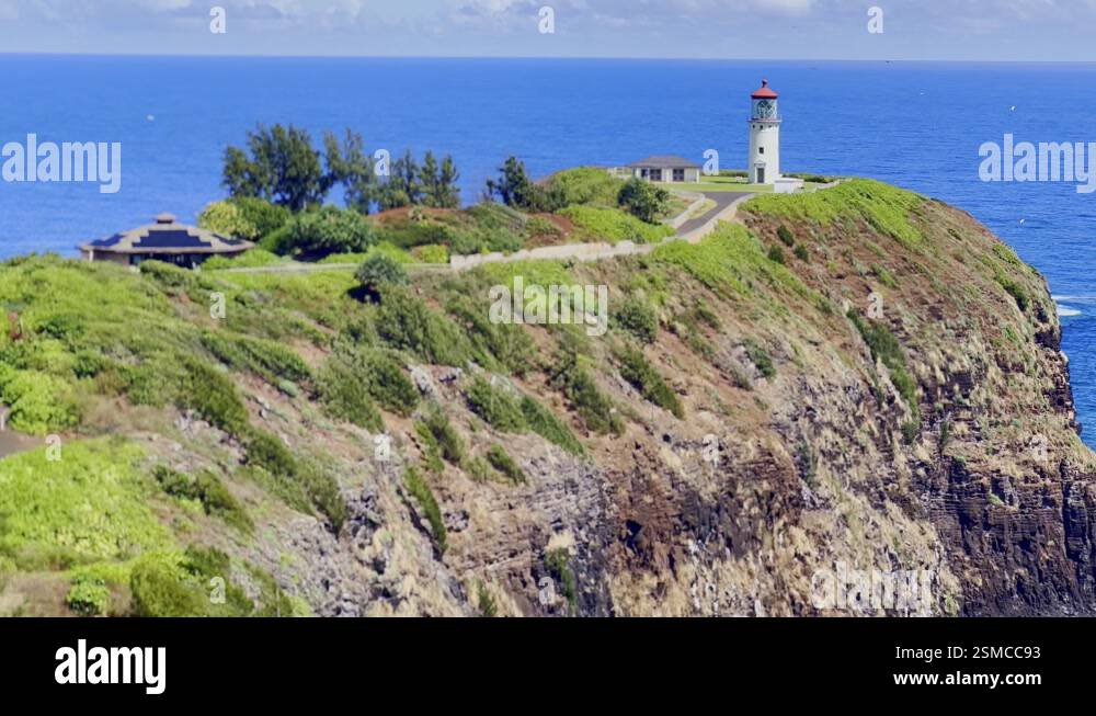 Cinematic long lens panning shot of the Kilauea Point Lighthouse along ...