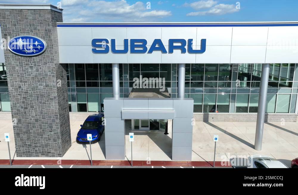 Subaru car dealership. Aerial push in shot on logo and name at high end ...