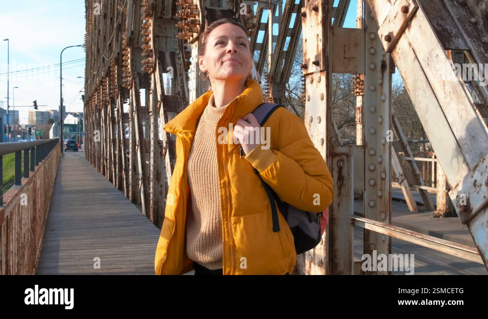 Woman on rusty urban bridge Stock Video Footage - Alamy