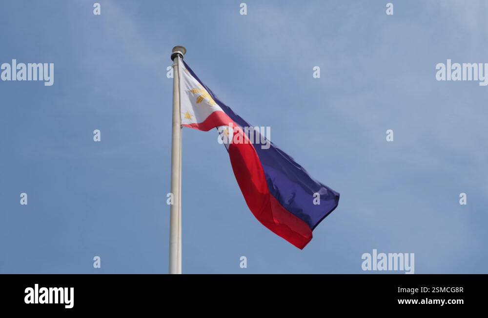 Philippine flag waving in the air with the blue skies as it background ...