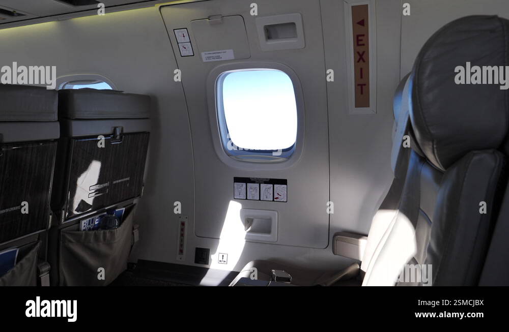 Interior view of commercial jet emergency exit. Tilt up Stock Video ...