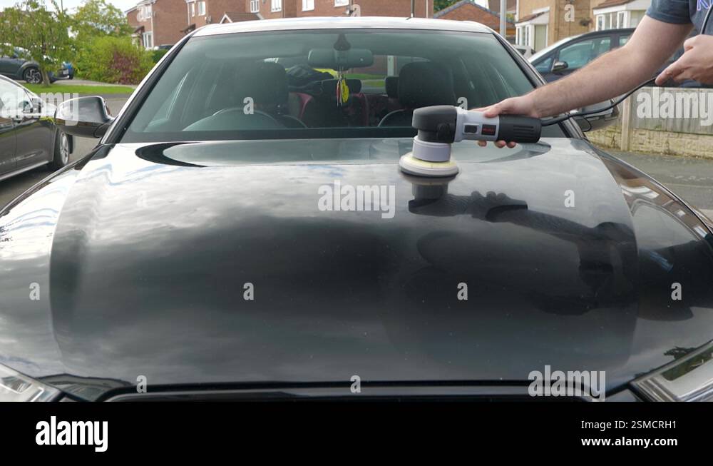 Polishing a black car bonnet hood with a machine polisher Stock Video ...