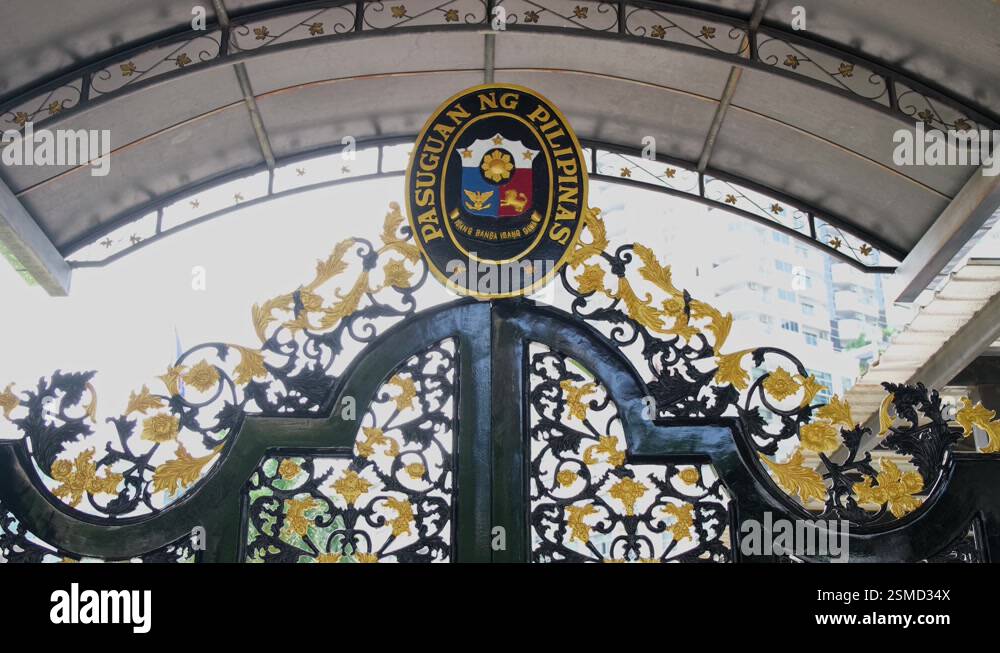 Zooming out of the Philippine Embassy seal on top of the front gate of ...