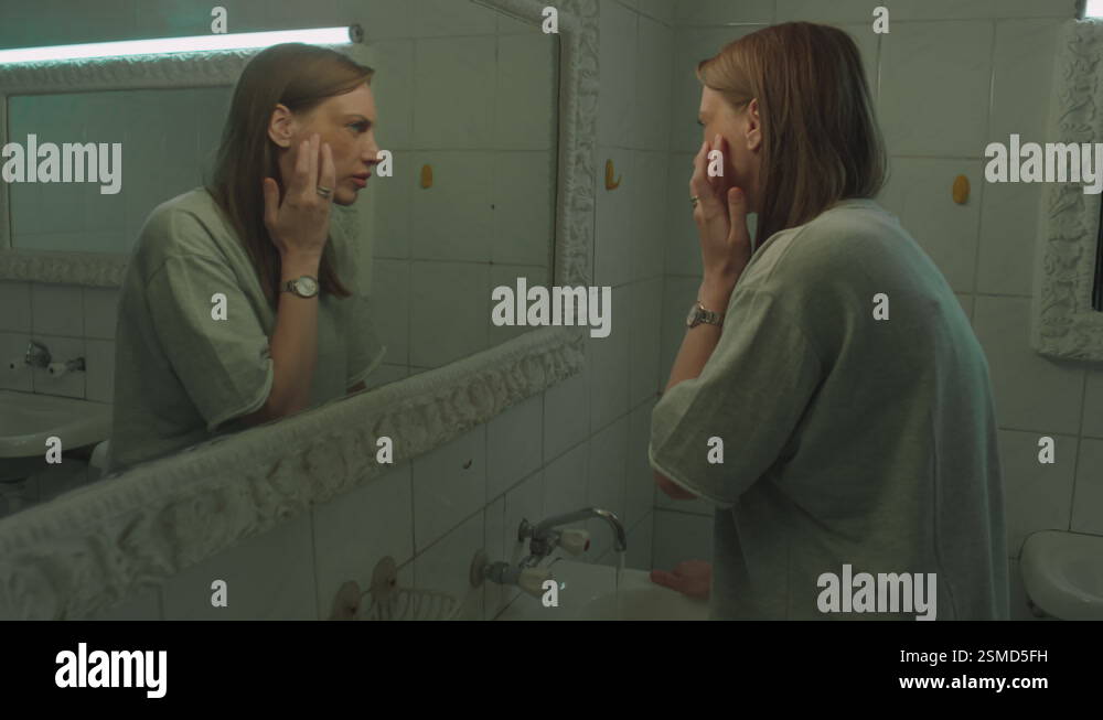 Upset Woman with Bruises and Scratches on Face Looking at Herself in ...