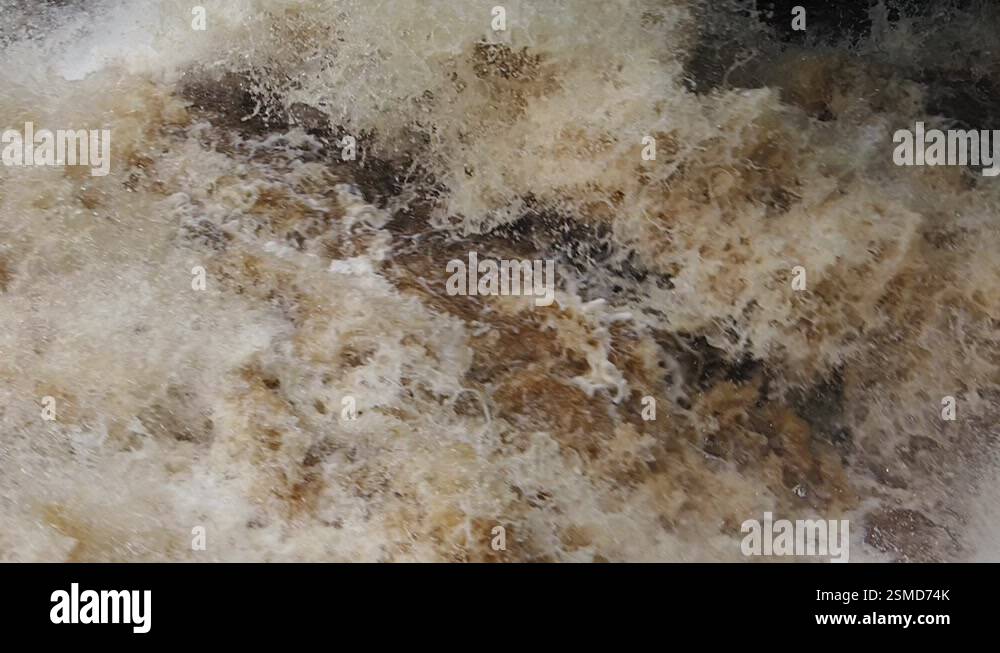 Peat stained flood waters in the River Ribble at Stainforth Force above ...