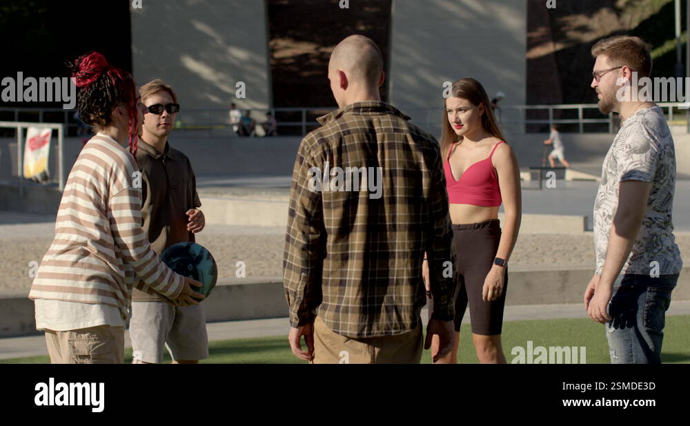 Icebreaker ball games. Young adults spend time outdoors on a sports ...