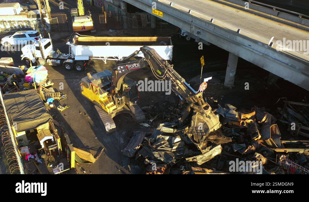 Aerial view following a excavator lifting fire damage to a truck at ...