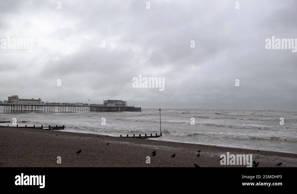 Choppy waves are whipped up by strong winds and break on the beach ...