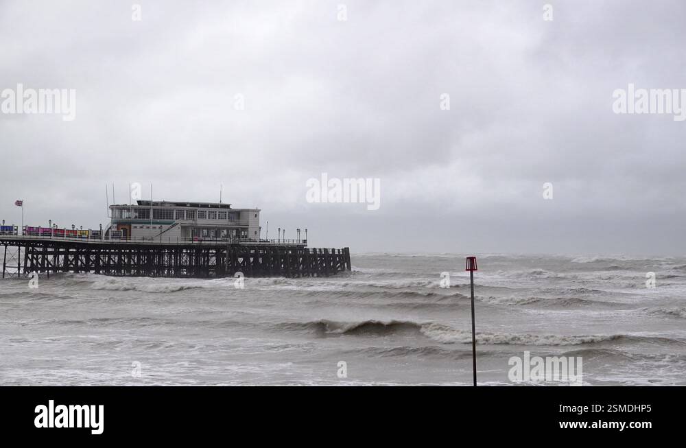 Choppy waves are whipped up by strong winds and break on the beach ...