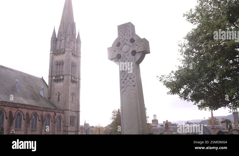 stone cross grave in graveyard in front of old european church in Stock ...