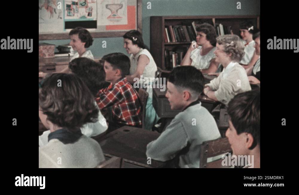 1960s: Boy speaking in front of his class. Students listening and ...