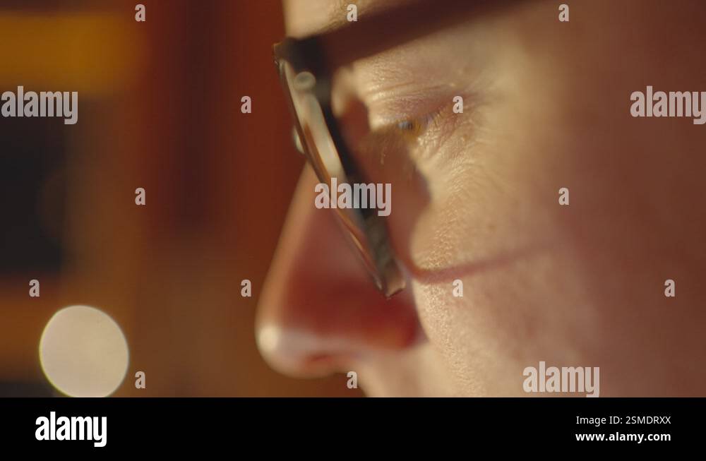Close up of caucasian male face squint eye and blink wearing glasses ...