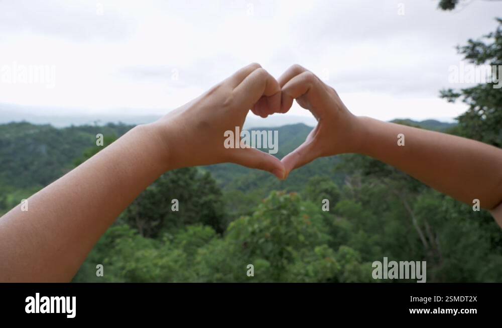 Two hands joined together to form a heart shape, a symbol of love and ...