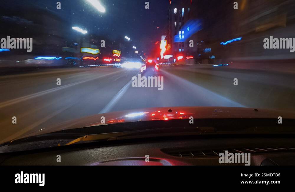 Timelapse footage of a fast night trip through a big city ending in a ...