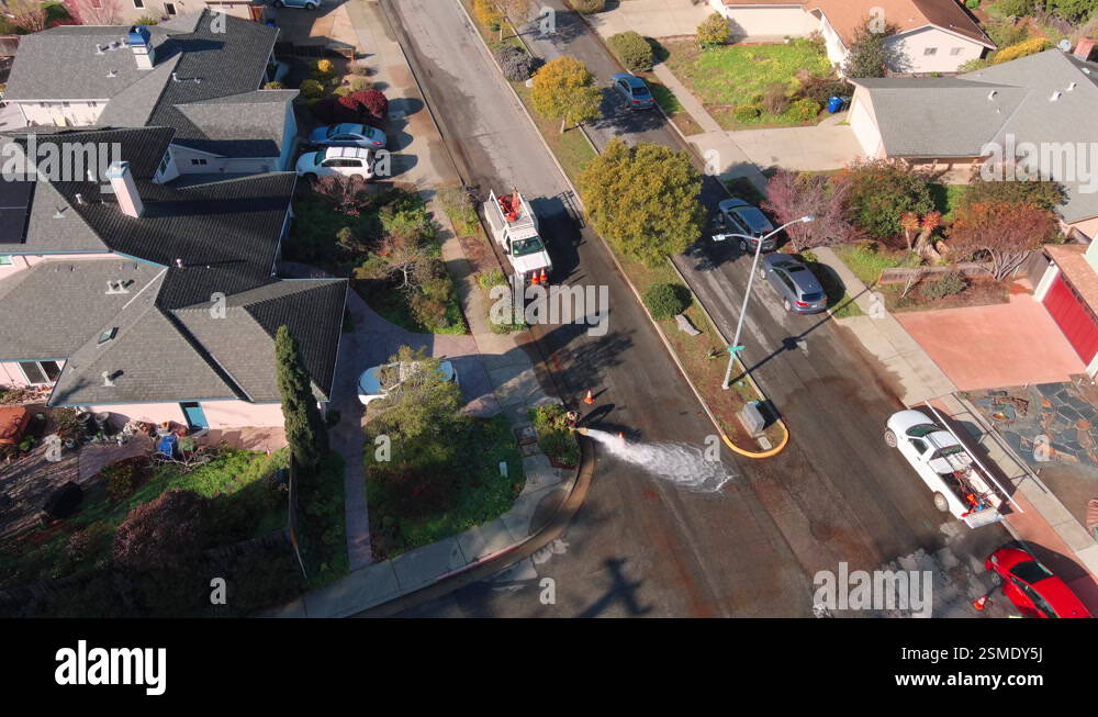 Working on a fire hydrant in Santa Cruz - water gushing on the suburban ...