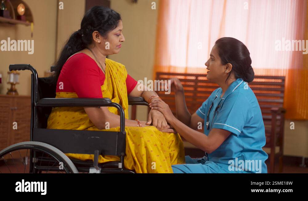 Indian Nurse Consoling by inspiring woman with disability on wheelchair ...