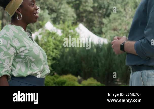 Tilt down slowmo of young confident Black woman shaking hands with male ...