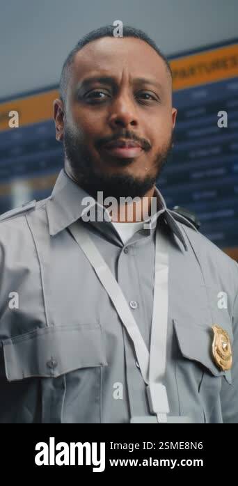 Portrait of Security Officer in Airport Terminal: African American TSA ...
