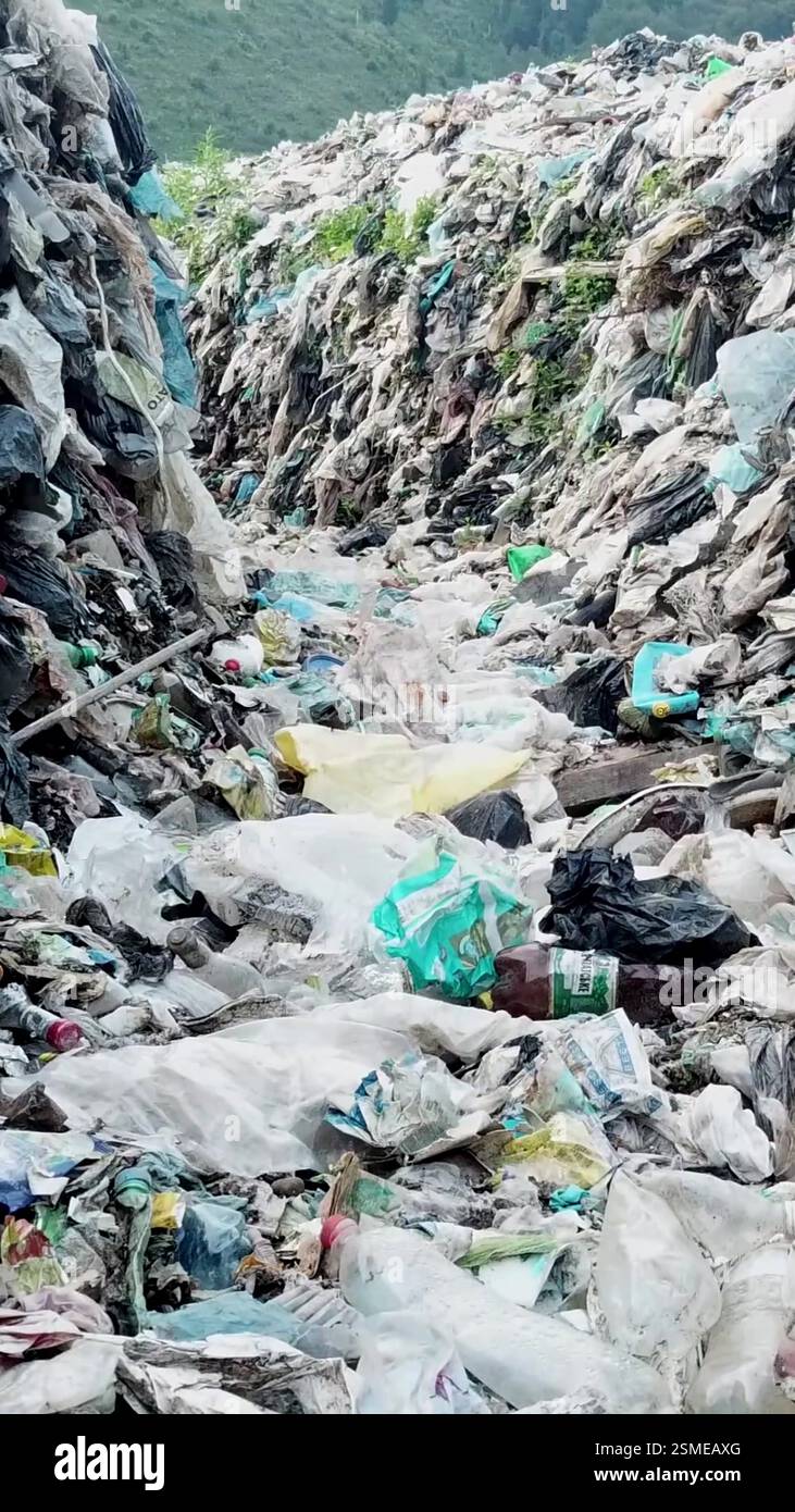 A landfill with a lot of garbage. Vertical video. Ecological damage of ...