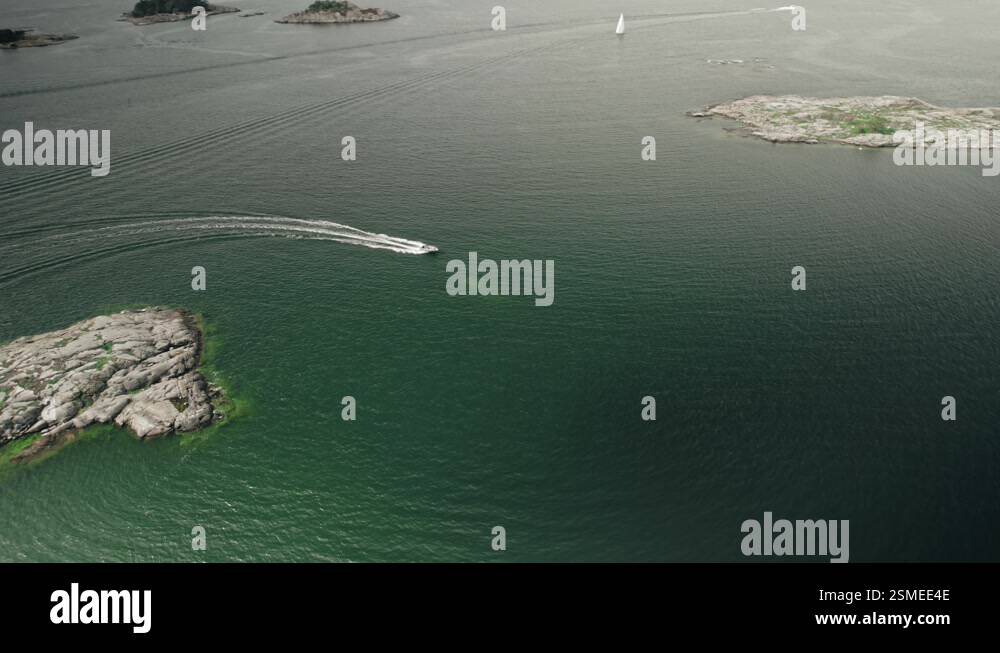Aerial, Drone, motorboat driving between two islands, Finland Stock ...
