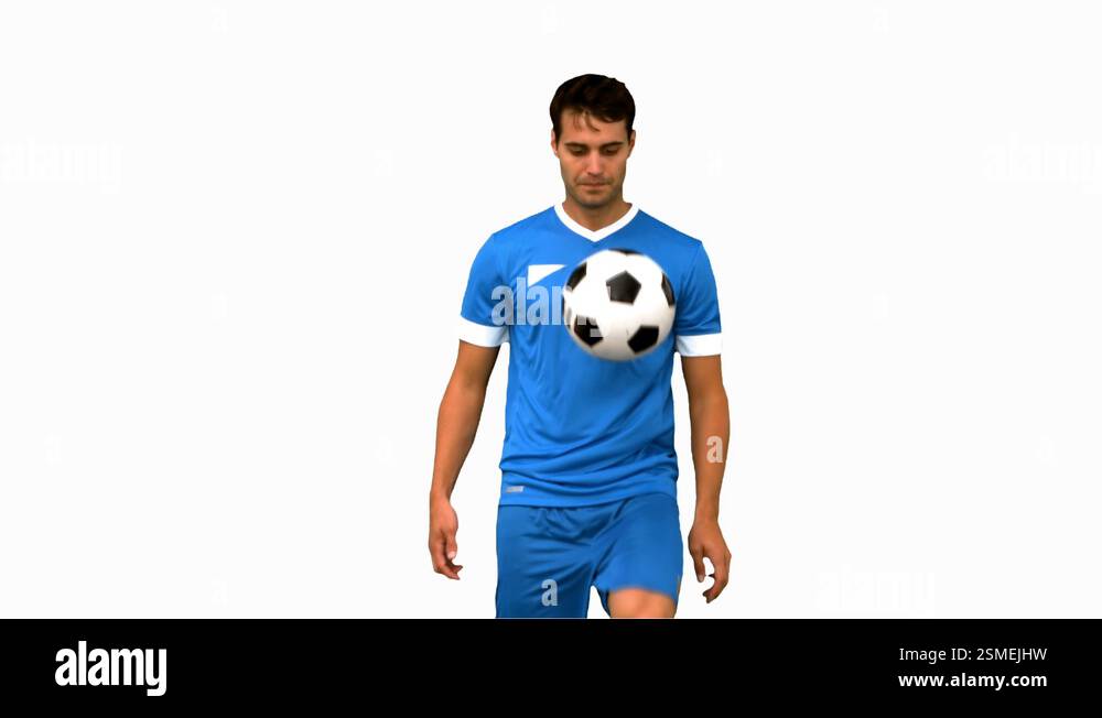Man juggling a football with his knee on white screen in slow motion ...