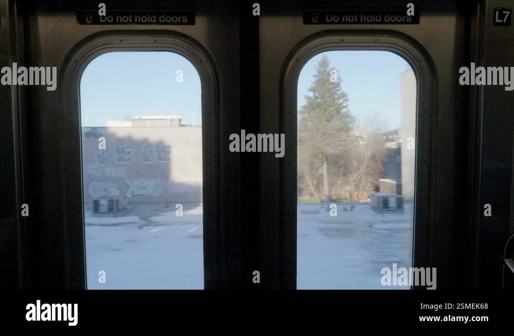Handheld POV shot looking out the window of a New York City subway car ...