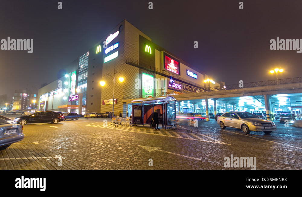 Bus stop near a shopping mall night timelapse hyperlapse, sign and ...