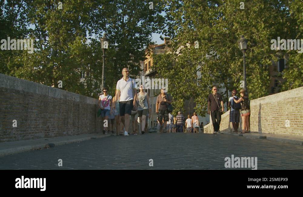 Crowds walk over bridge 3 (slomo dolly Stock Video Footage - Alamy
