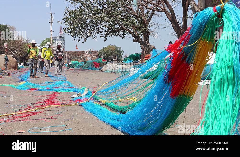 Workers repair fishing nets at the Sassoon Docks in Mumbai Stock Video ...