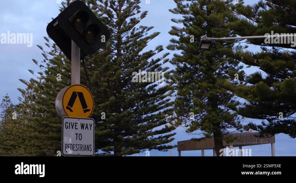 A pedestrian crossing sign with flashing yellow lights In Australia ...