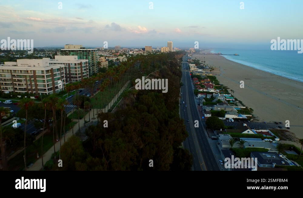 Aerial Forward Beautiful Shot Of Buildings On Cliff By Road At Beach ...