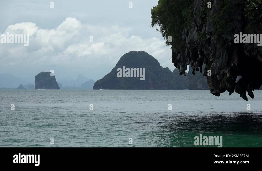Footage of ocean side of rocky lagoon wall is a shallow body of water ...
