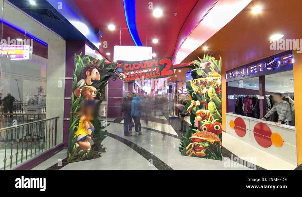 Walking through illuminated hall of Imax cinema inside a shopping mall ...
