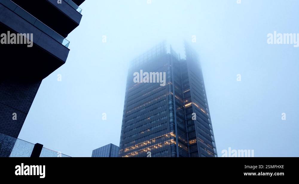 Time lapse of morning fog covering the top of a building located on 8th ...