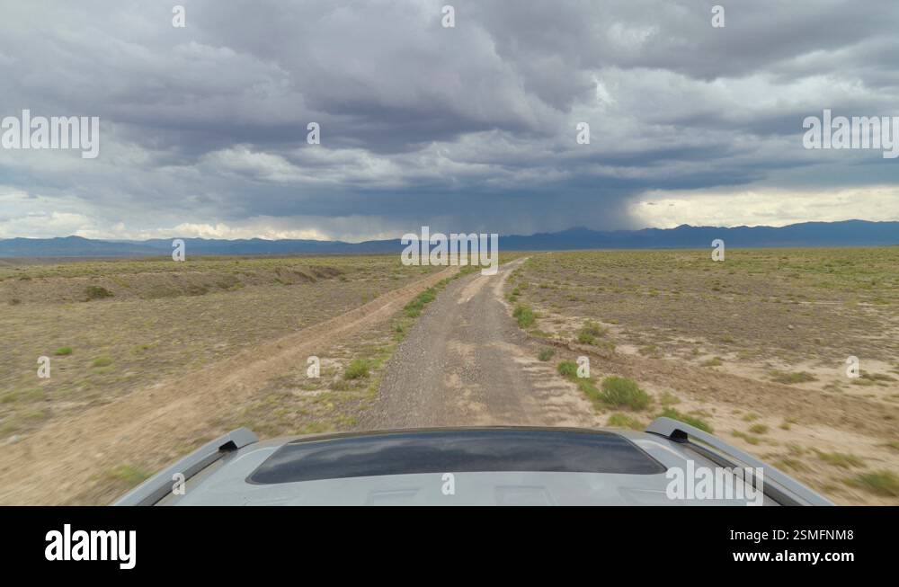 The car is driving through a wild desert area in the mountains Stock ...