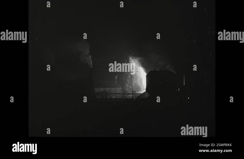 United States 1940s: A nighttime view of a steel mill in the 1940s. The ...
