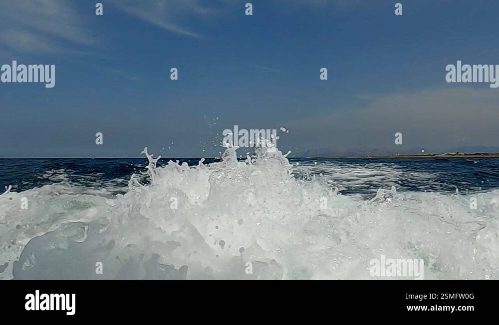 Unusual low-angle water surface pov of motorboat wake trail with boat ...