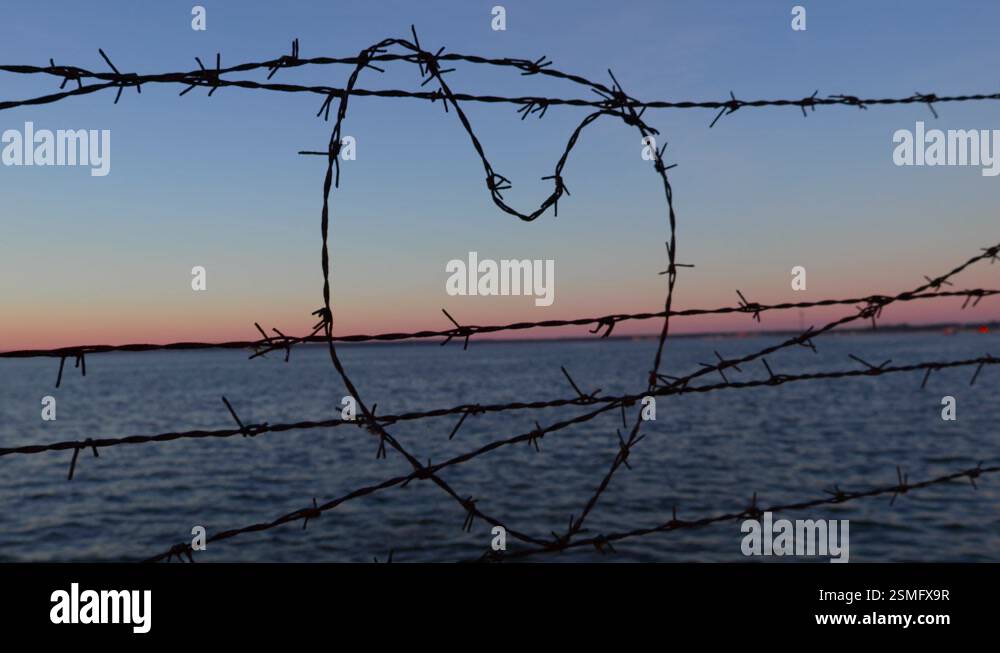 Slowly moving footage of a barbed wired heart in the sunset in Tallinn ...