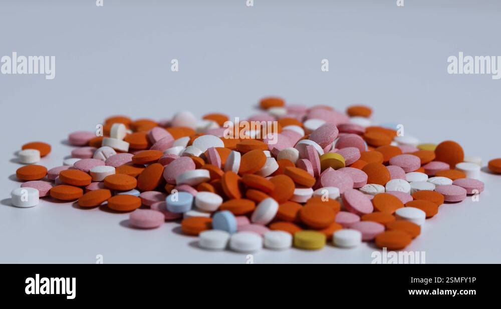 Pile of multicolored pills on white surface. focus shifting shot Stock ...