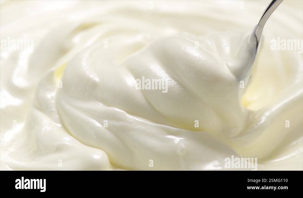 Sour cream or greek yogurt scooping with a spoon, swirl, rotating ...
