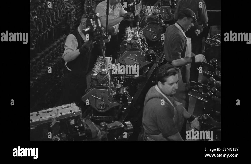 Detroit 1940s: Workers assemble automobile engines on an assembly line ...