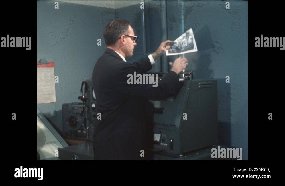 1960s: Teletype machine and radio equipment in a room. Man picks up a weather Stock Video ...