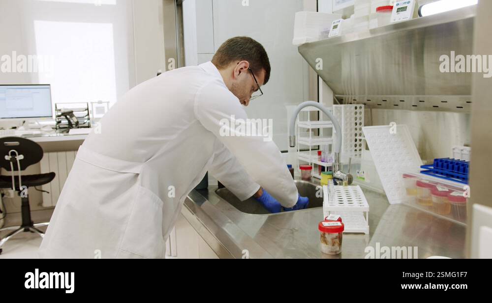 Scientist Using Micropipette to Mix Liquids in a Test Tube in a Modern ...
