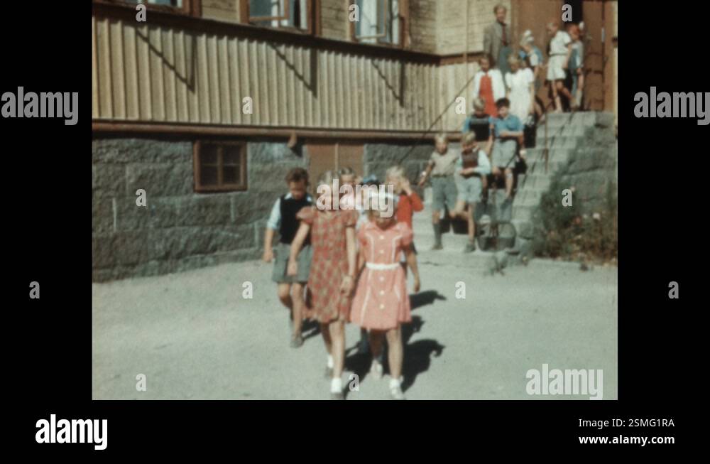 1940s: Children exit schoolhouse and walk down steps into courtyard ...