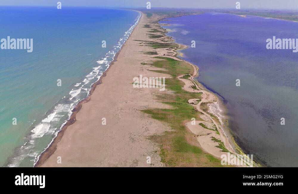 Drone footage captures the stunning beauty of a narrow sand spit ...