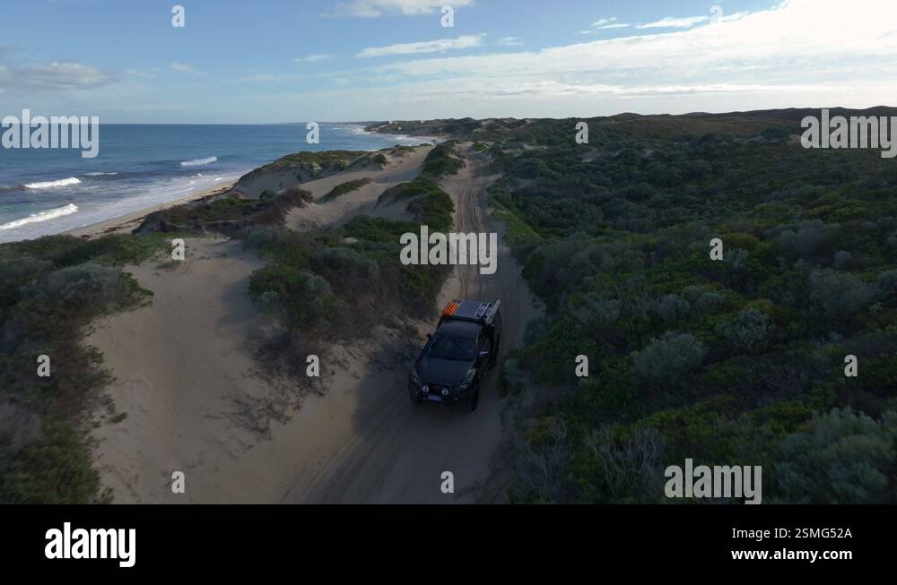 Beautiful coastal sand dune system as a 4WD navigates the narrow tracks ...