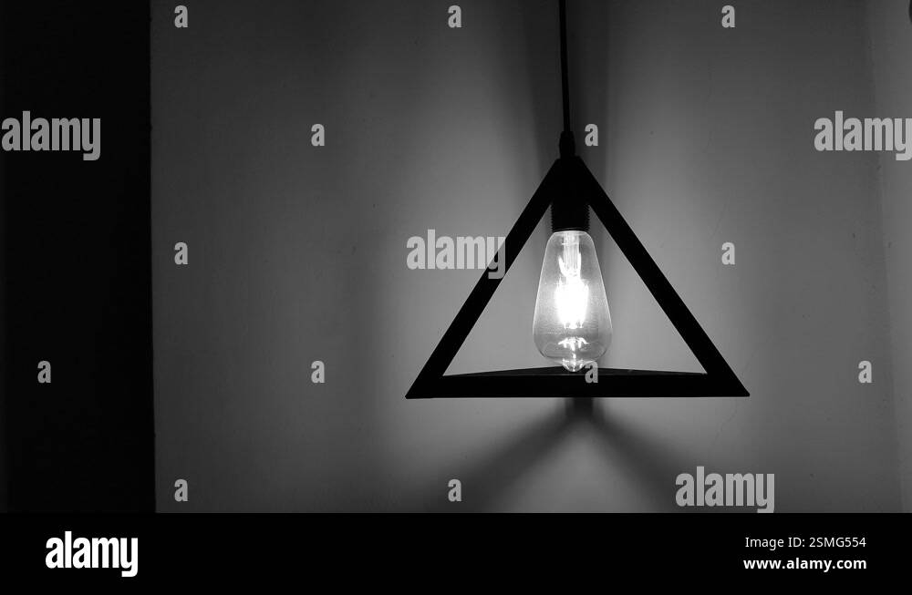 Close up black and white triangle lamp making light and shadow on the ...
