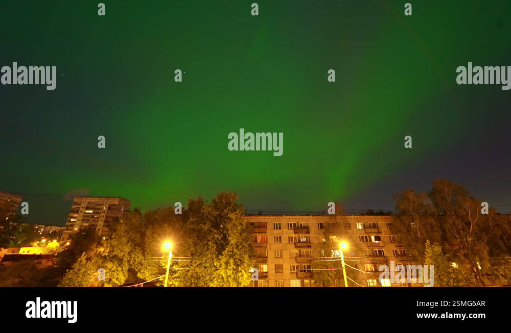 Colorful green Northern lights above post soviet city suburban ...
